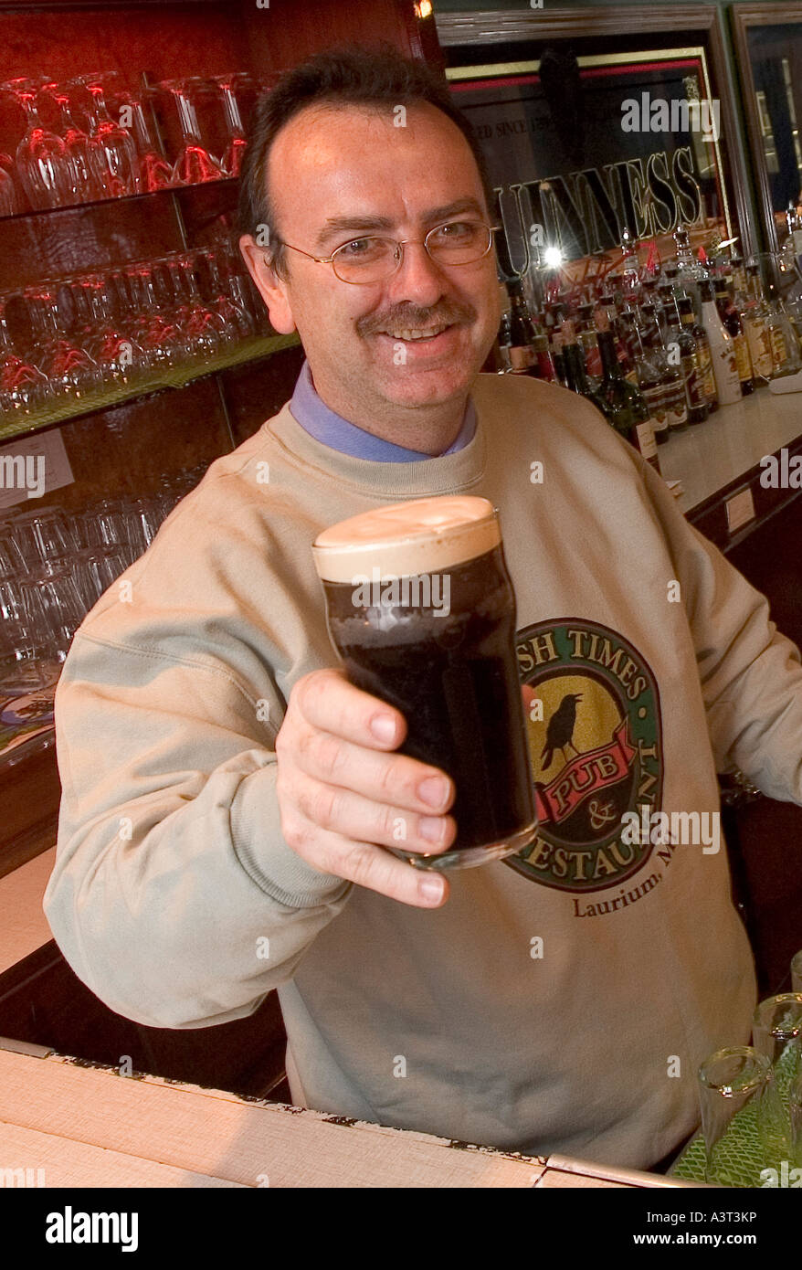 Irish Pub owner holds glass of Guinness Beer Stock Photo - Alamy