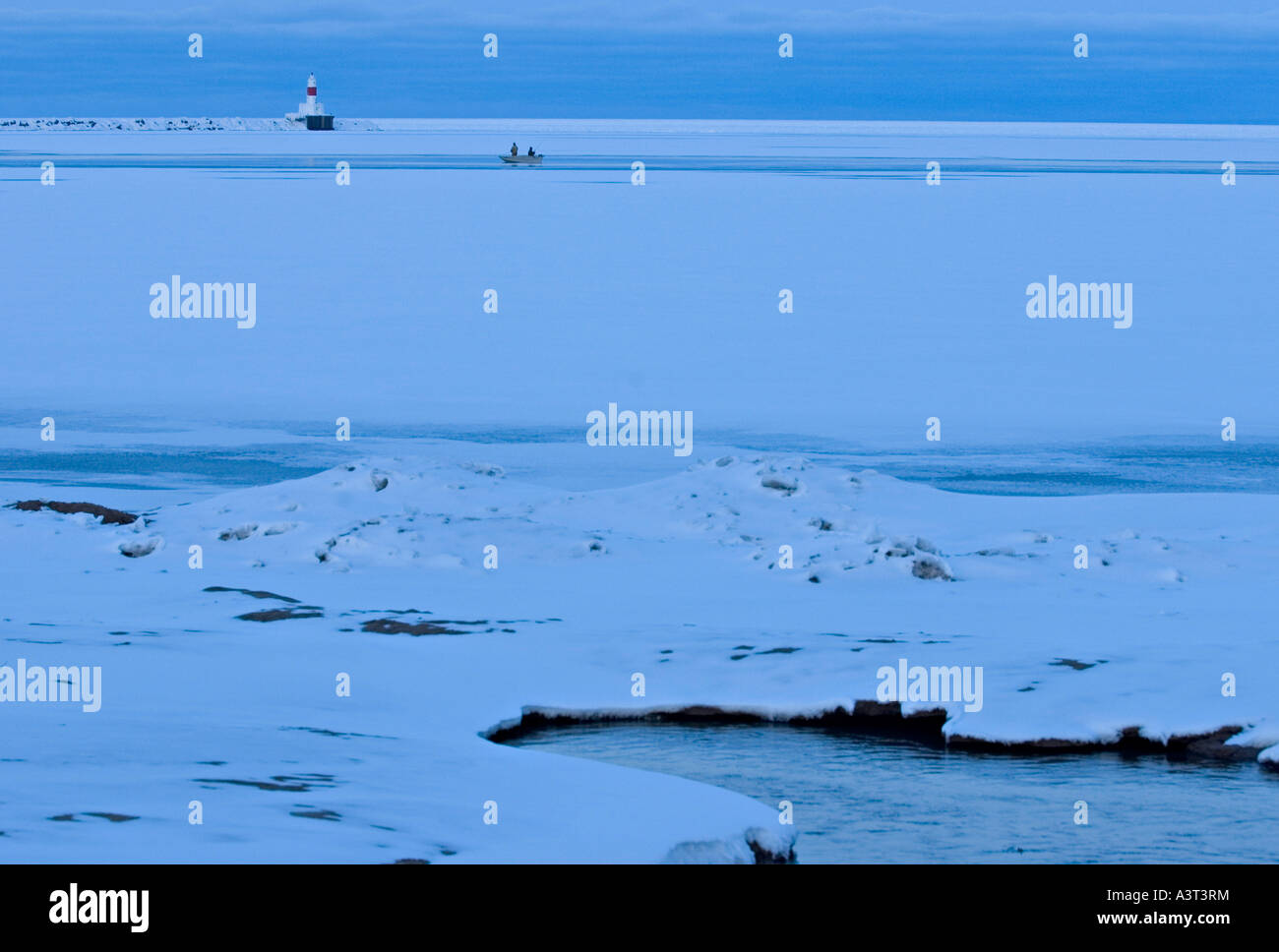 Salmon fishermen fish from a boat in a narrow strip of open water on ...