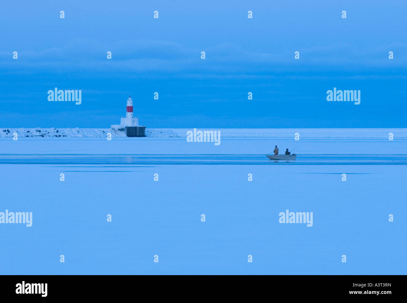 Salmon fishermen fish from a boat in a narrow strip of open water on ...