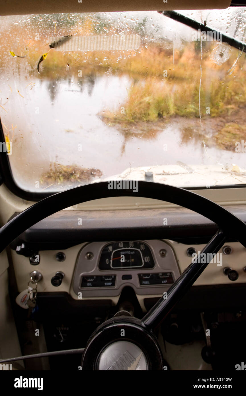 A Toyota Land Cruiser stuck in the mud of a beaver pond during a ...