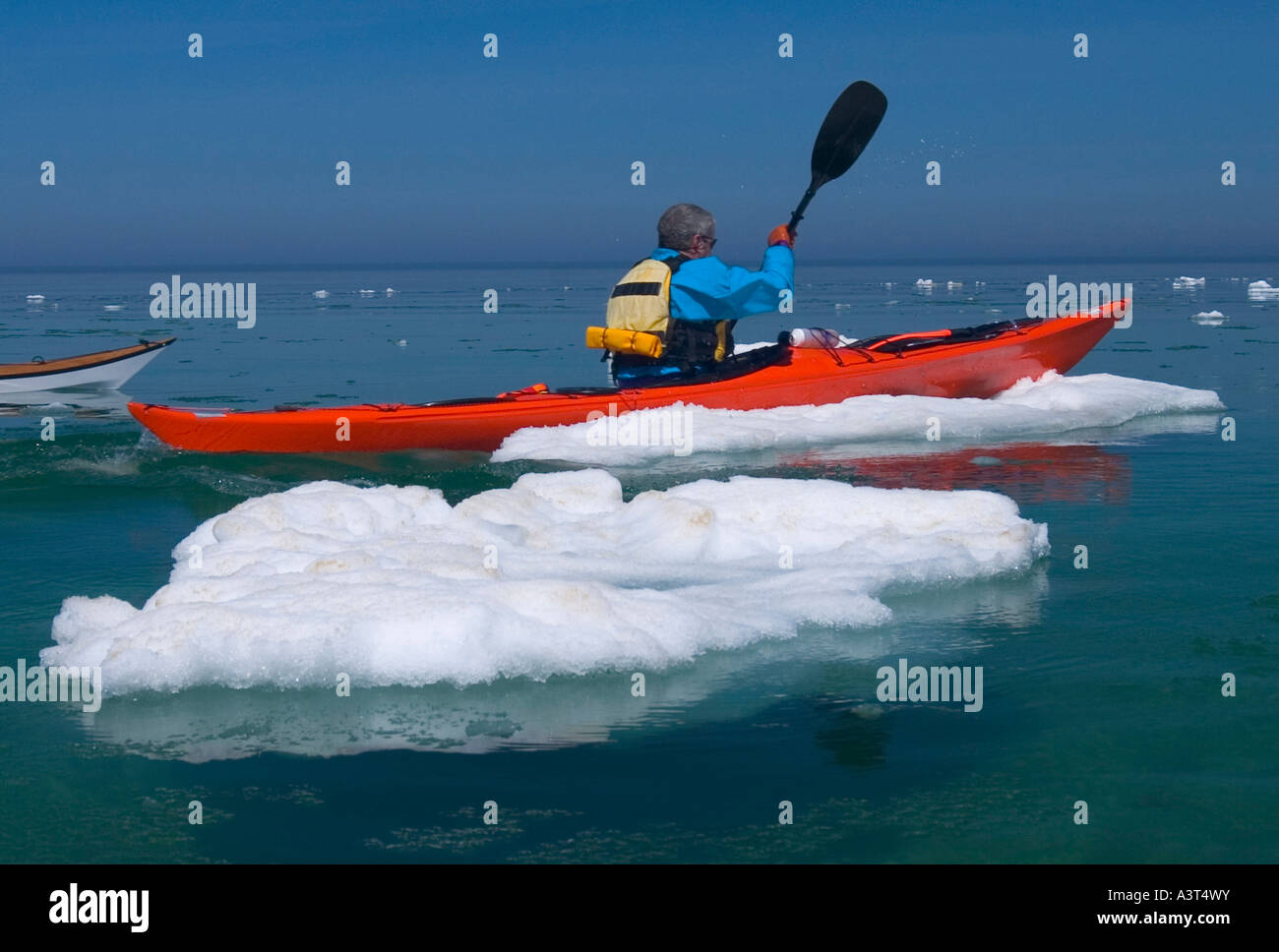 A sea kayaker paddles through ice floating in Lake Superior at Pictured ...