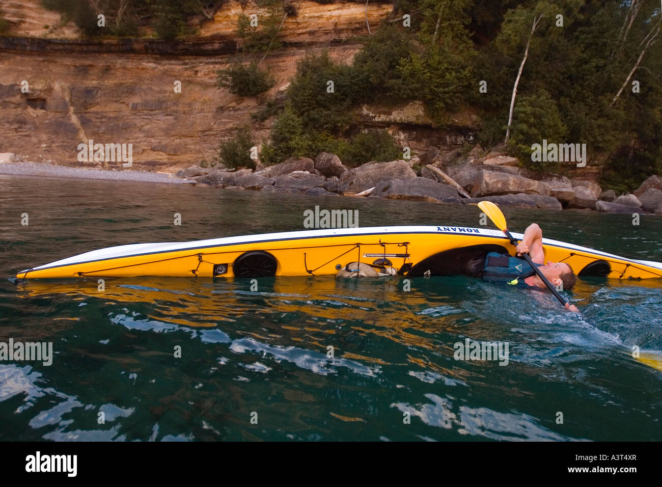 Sea kayaker completing eskimo roll on Lake Superior, Grand Island ...