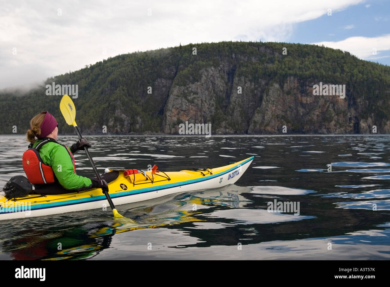 A sea kayaker crosses Old Woman Bay in Lake Superior Provincial Park ...