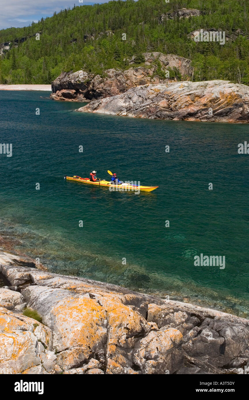 A group of sea kayakers paddle the rugged shoreline near Ryan Point in ...