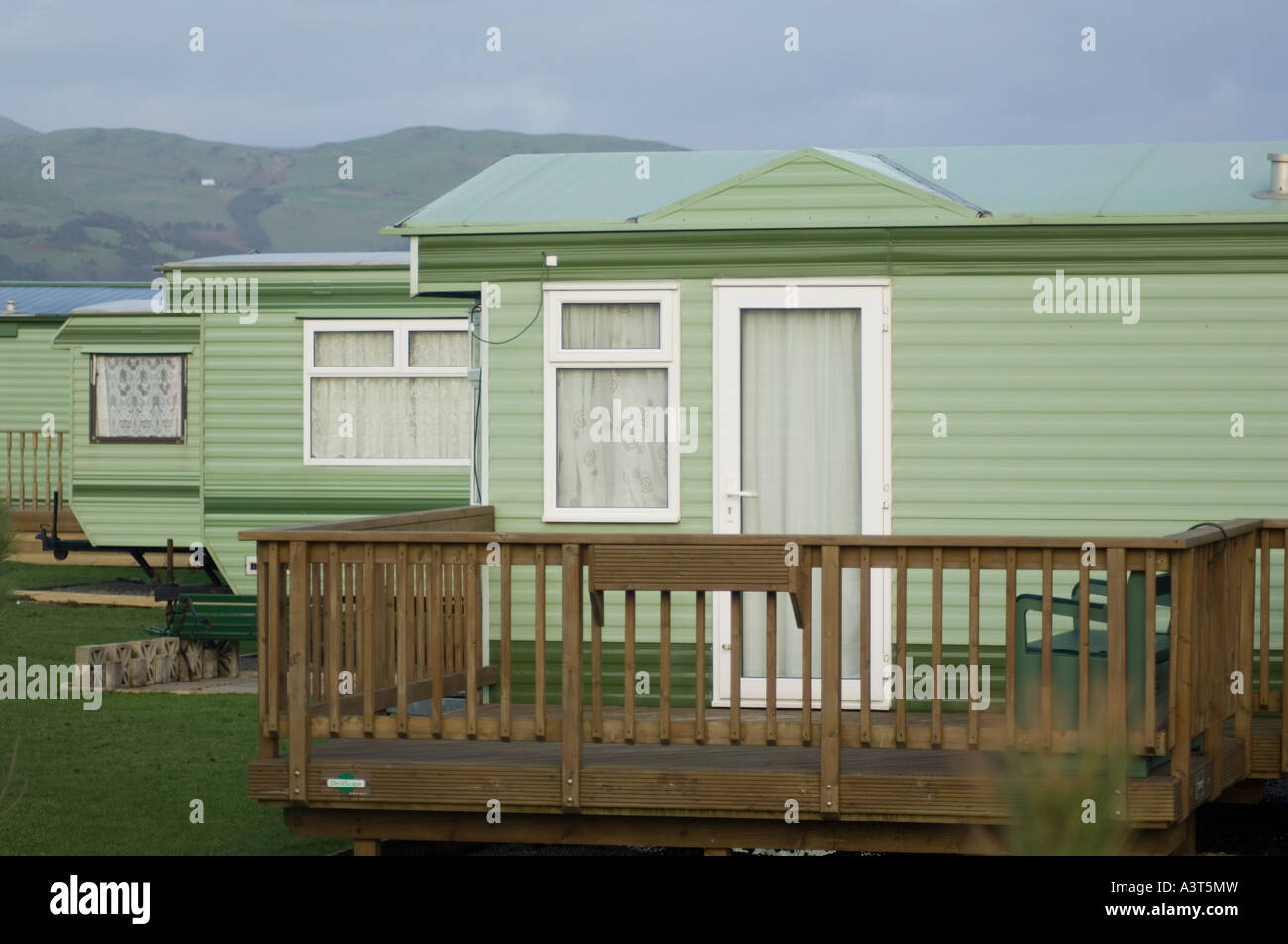 Row of green static caravans on campsite Ynyslas near Borth Ceredigion ...
