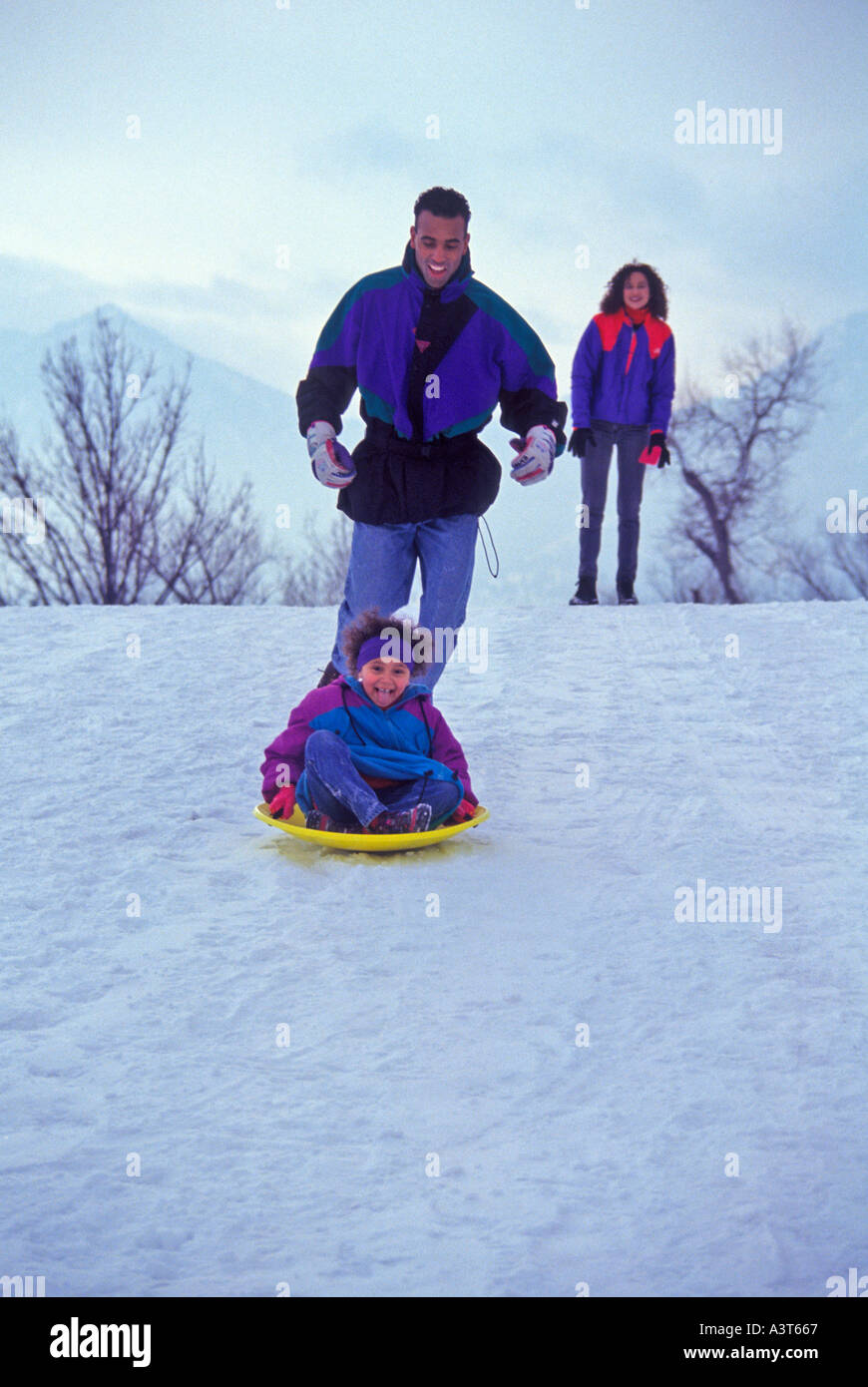 family sledding in the snow Stock Photo - Alamy