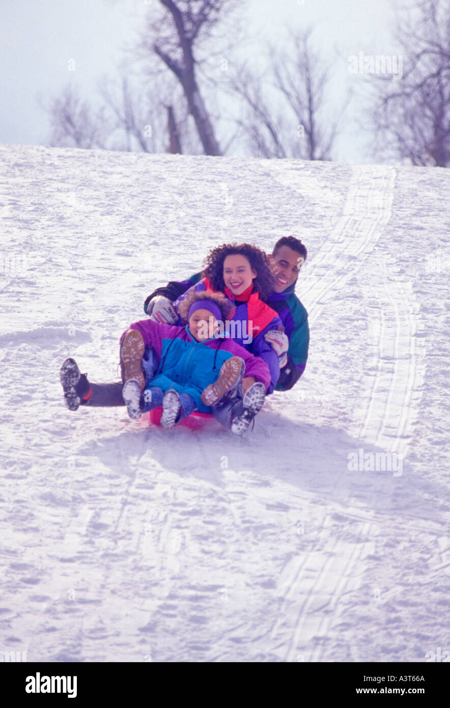 Father sledding daughter in snow hi-res stock photography and images ...