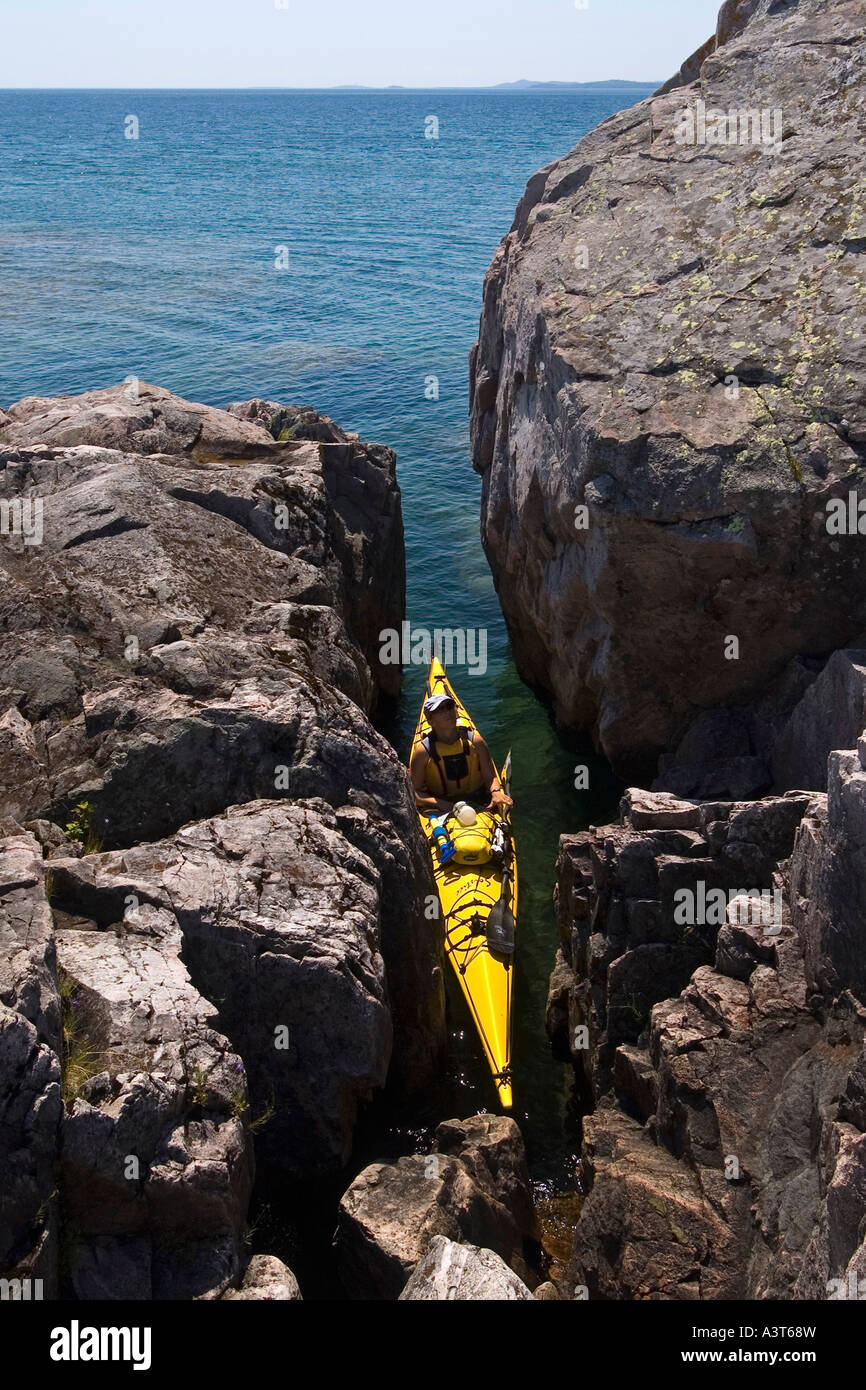 A sea kayaker explores Granite Point on Lake Superior between Big Bay ...