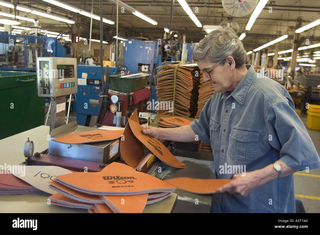 Workers manufacture footballs at Wilson Sports factory Stock Photo - Alamy