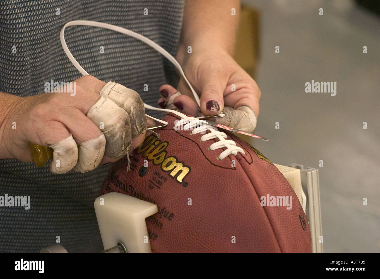 Workers manufacture footballs at Wilson Sports factory Stock Photo - Alamy