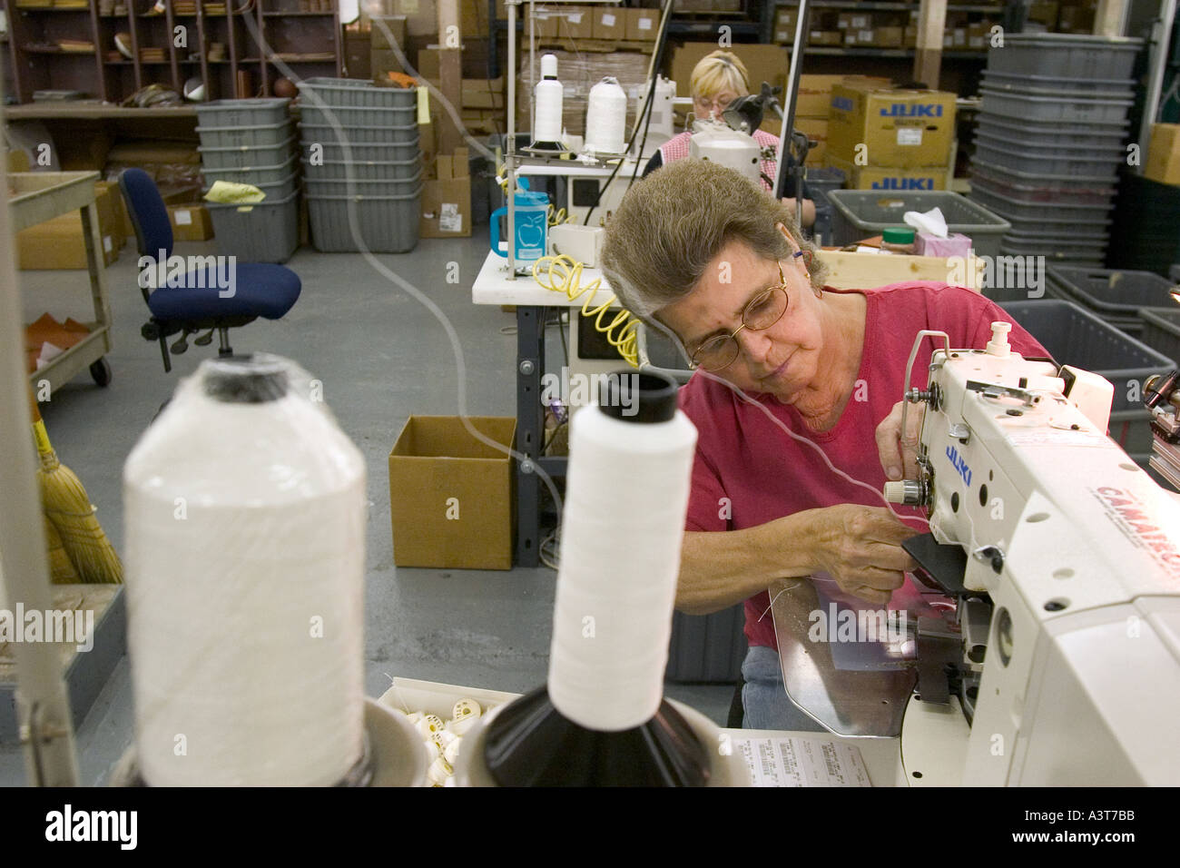 Workers manufacture footballs at Wilson Sports factory Stock Photo - Alamy