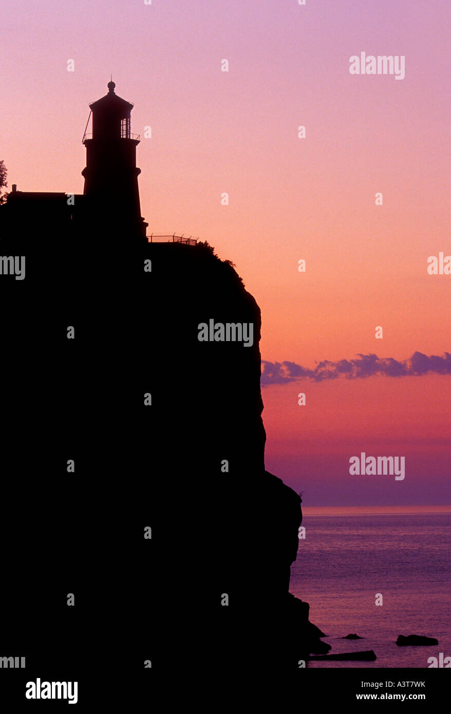 THE SPLIT ROCK LIGHTHOUSE IS SILHOUETTED AT DAWN AT SPLIT ROCK ...