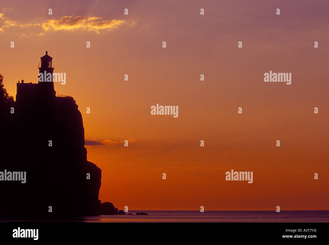 THE SPLIT ROCK LIGHTHOUSE IS SILHOUETTED AT DAWN AT SPLIT ROCK ...