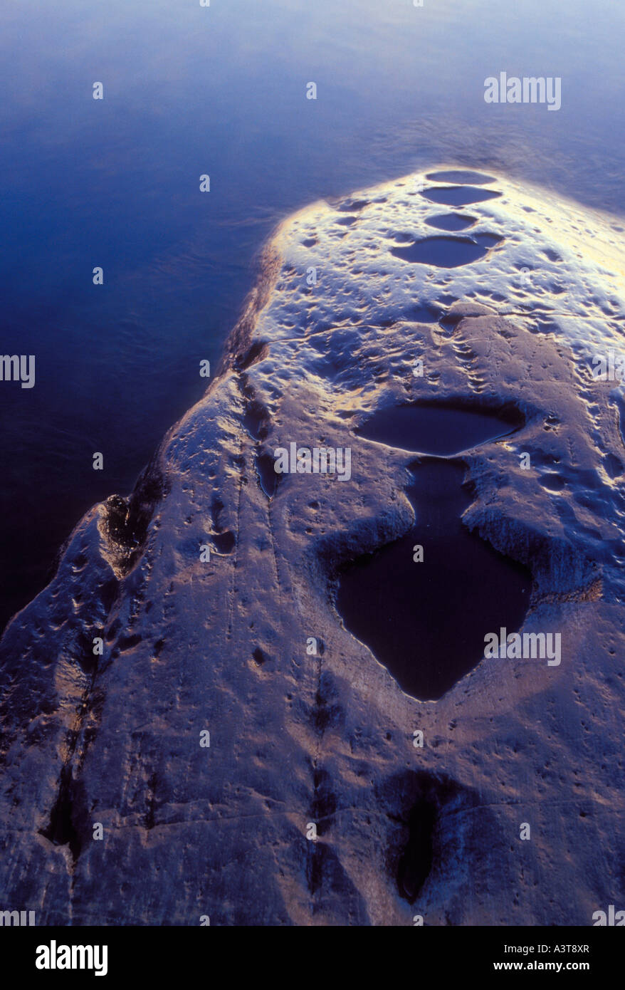 A pockmarked rock on Lake Superior in Pukaskwa National Park near White ...