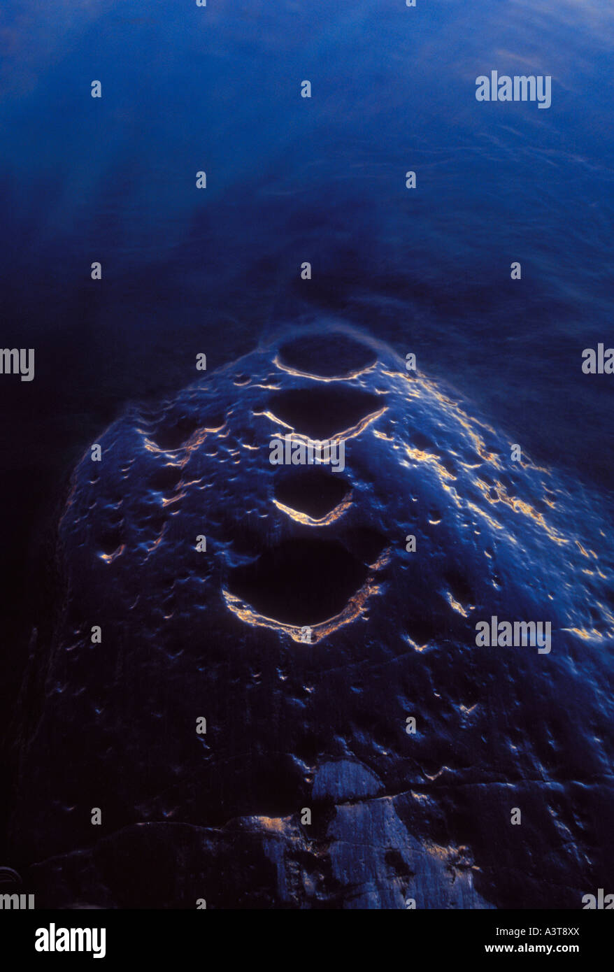 A pockmarked rock on Lake Superior in Pukaskwa National Park near White ...