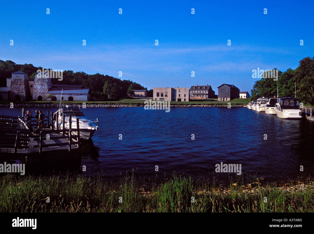 BOATS DOCK IN SNAIL SHELL HARBOR NEAR NINETEENTH CENTURY BUILDINGS AT ...