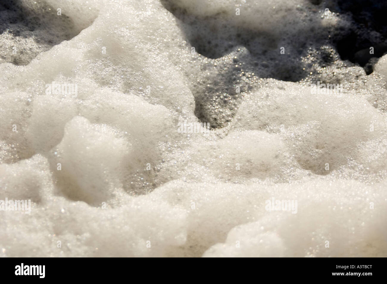 spume sea spray on beach during a storm Stock Photo - Alamy