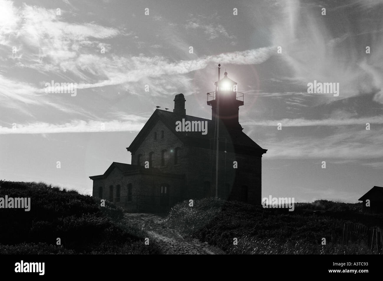 Lighthouse on a hill with beacon light lit rays. North lighthouse ...