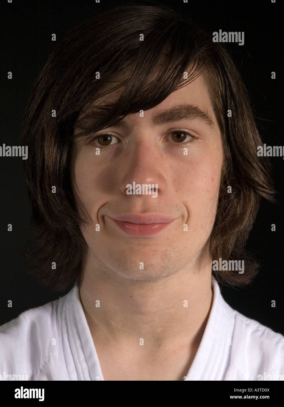Young man aged 16 with awkward or embarrased smile Stock Photo - Alamy