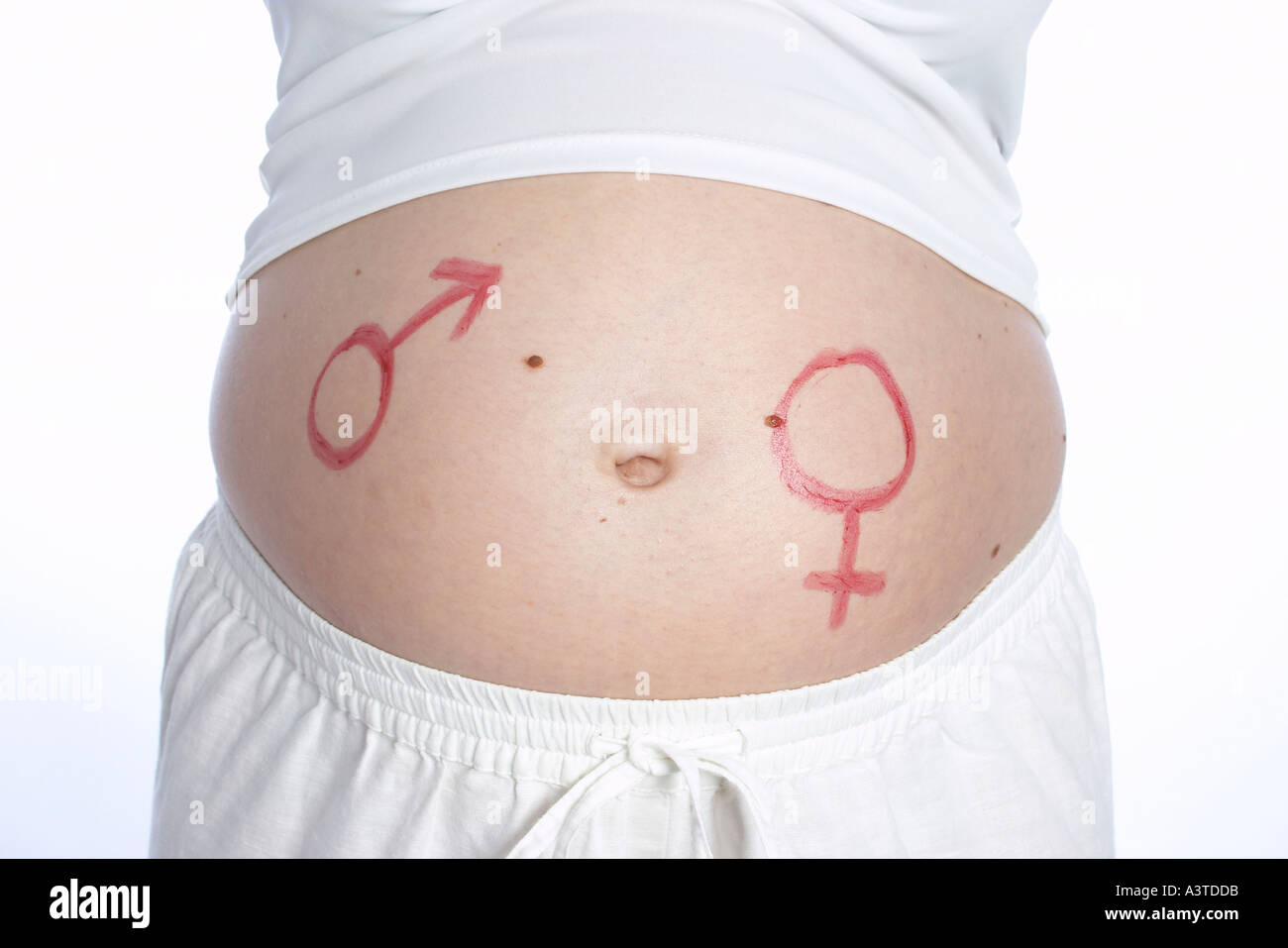 pregnant woman, 7th month, signs "male" and "female" on belly Stock ...
