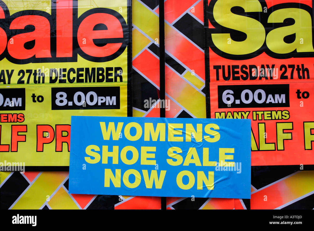 Shop windows with posters advertising half price sale Stock Photo - Alamy