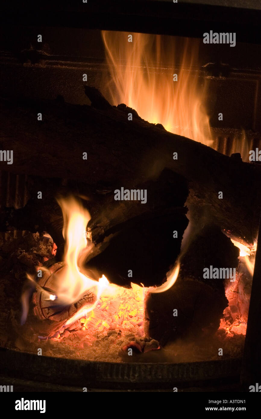 Burning logs alight inside a wood burning stove Stock Photo - Alamy