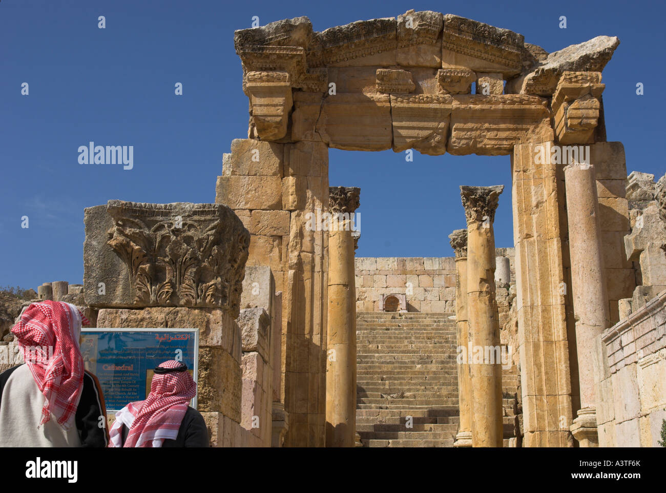 Jordan Jerash archeological site cathedral entrance gate with two men ...