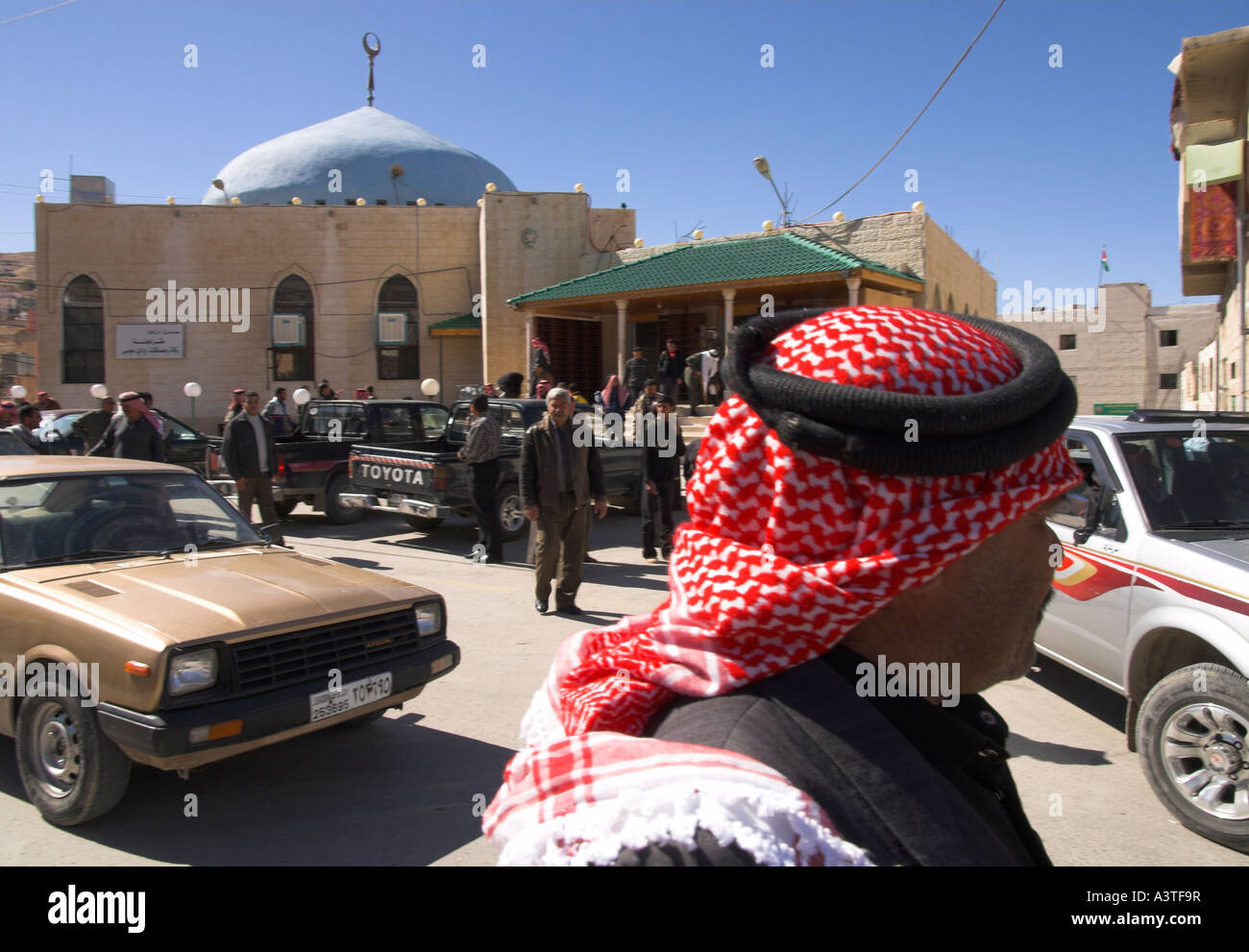 Jordan Petra Wadi Musa view with local mosque and man wearing red ...