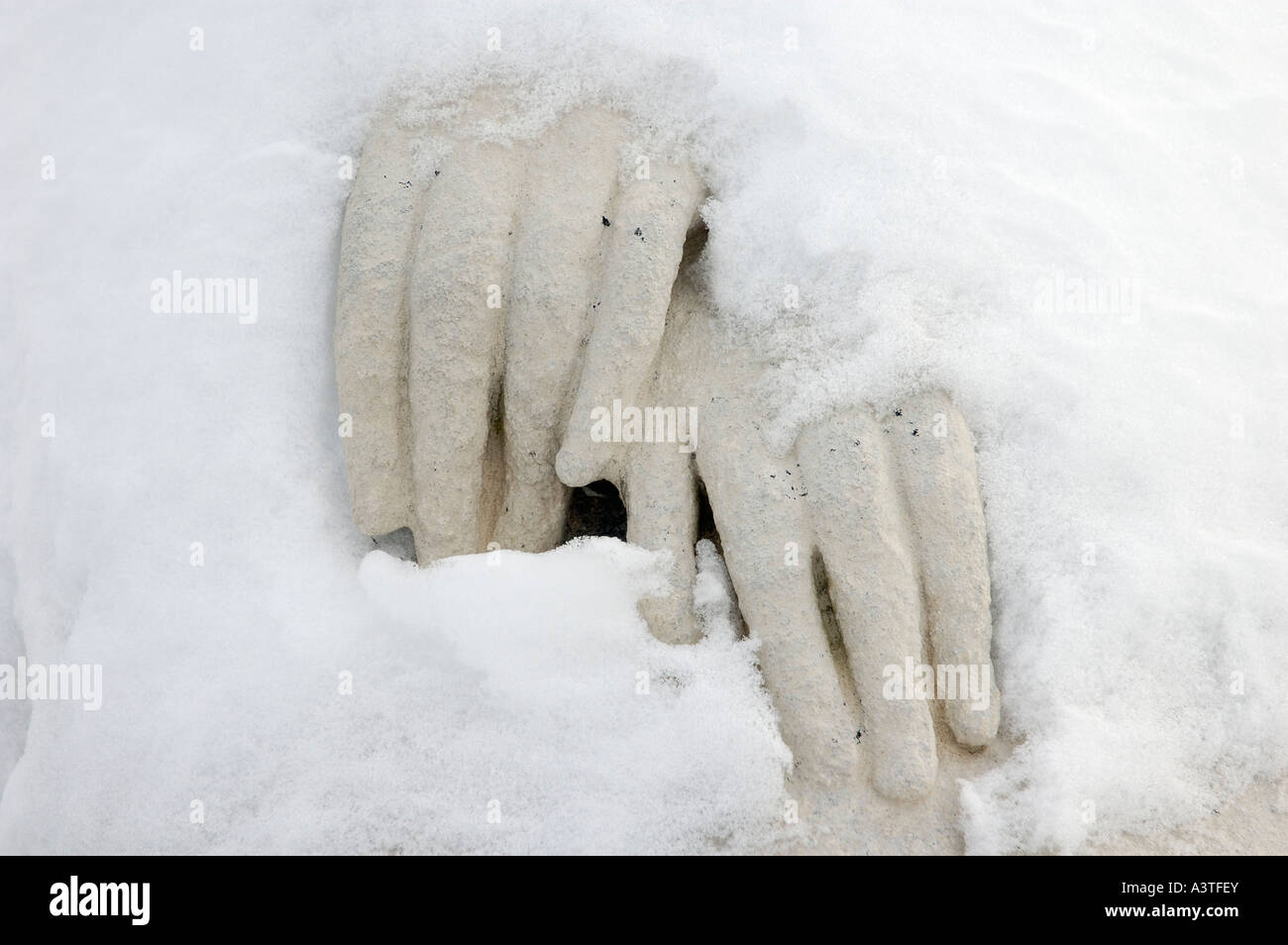 Snow covered hands of a statue Stock Photo - Alamy