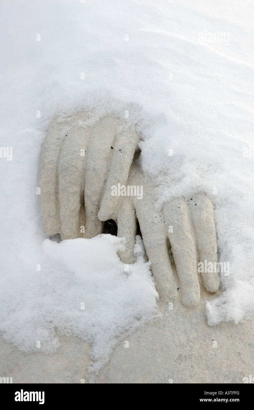 Snow covered hands of a statue Stock Photo - Alamy