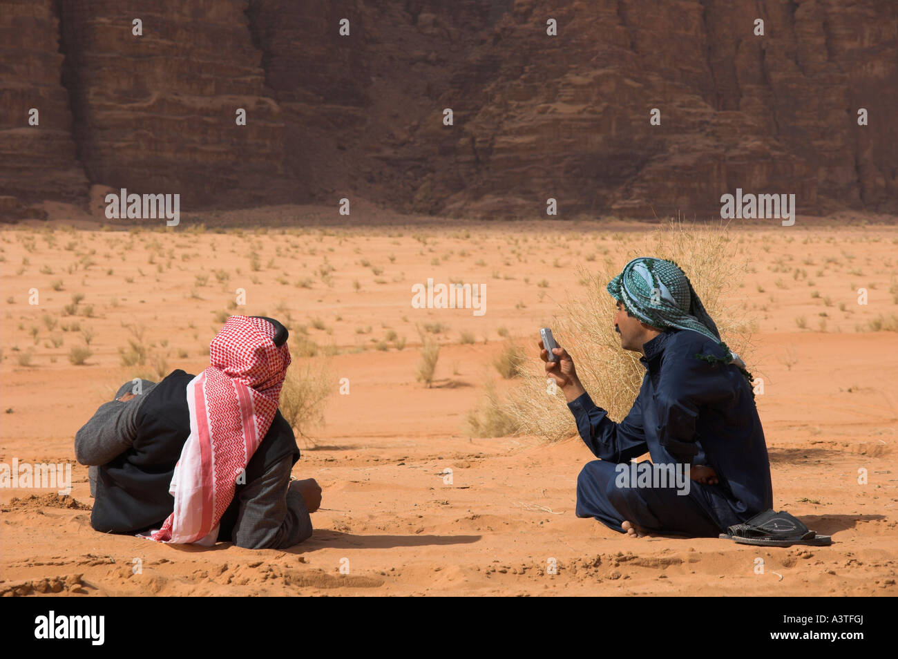 Jordan Wadi Rum desert two bedouin men seating in the desert with ...
