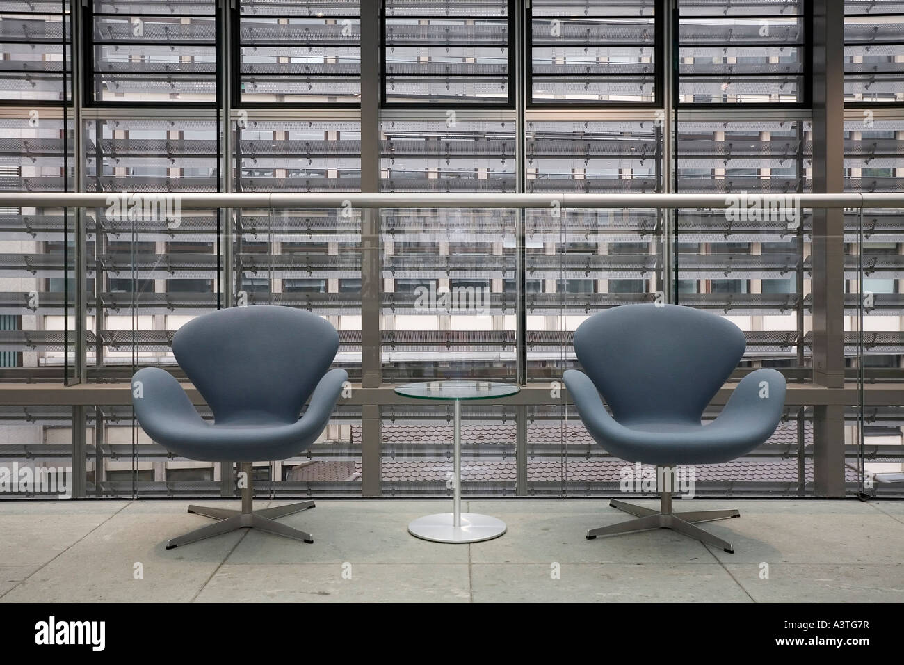 Two chairs standing in the foyer of a modern office building Stock ...