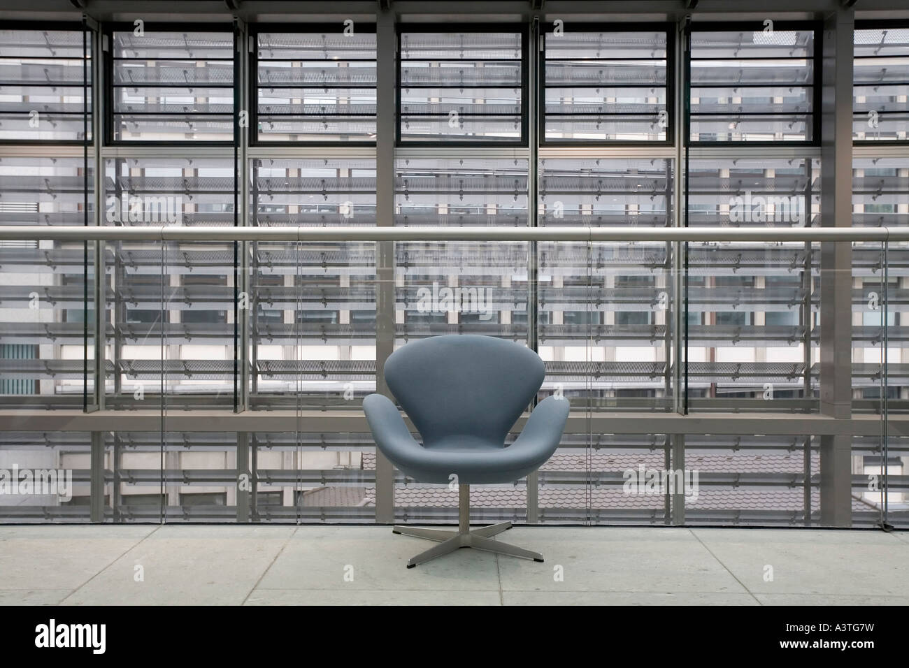 One single chair standing in the foyer of a modern office building ...