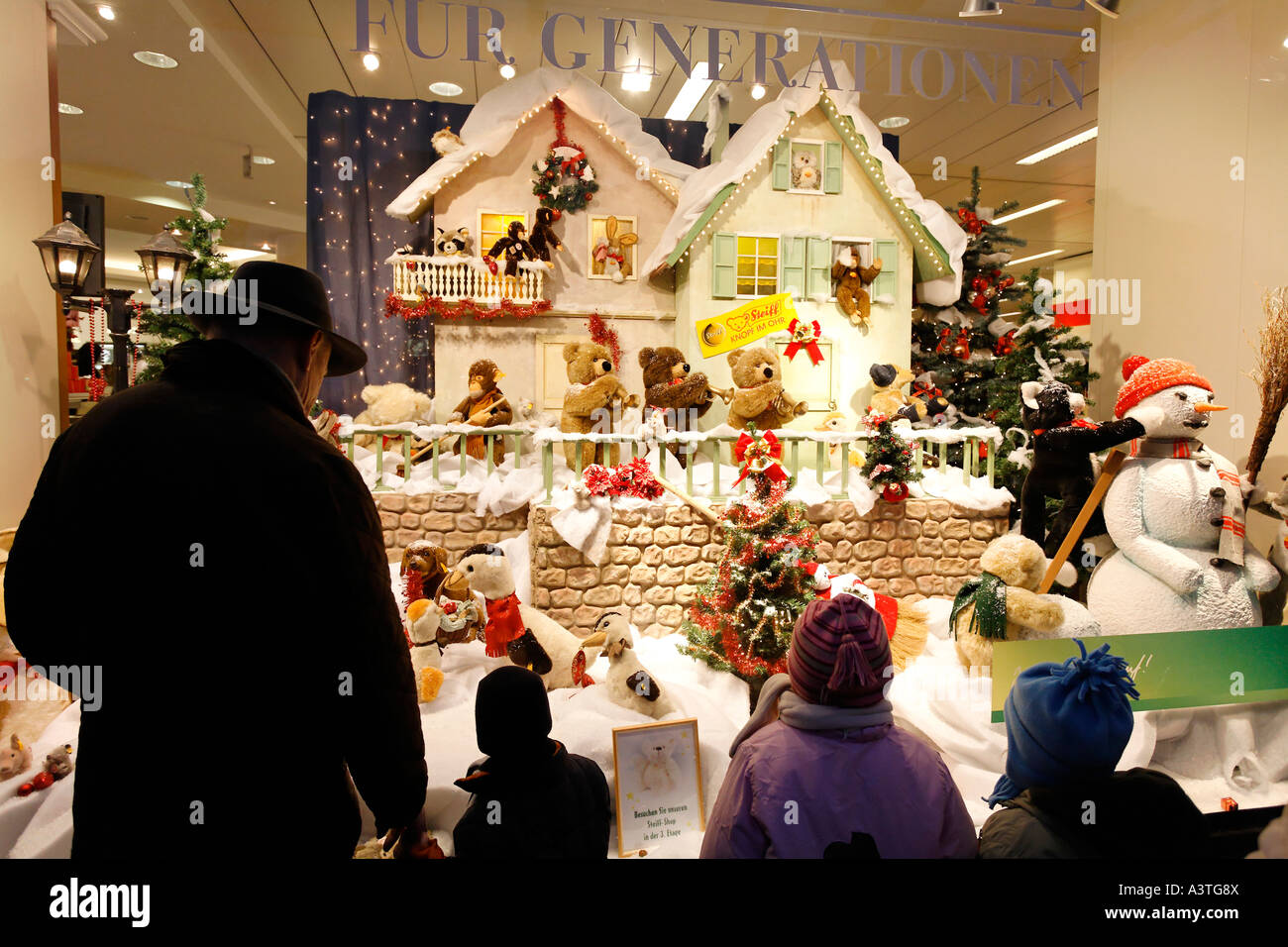 Father and children look at a christmas window in a department store ...