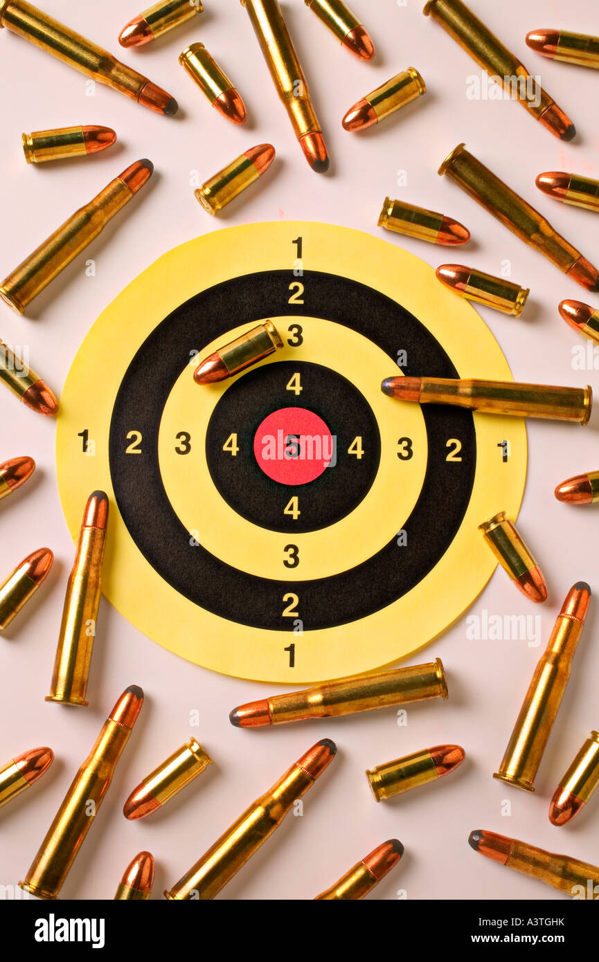 Yellow target with bullets Stock Photo - Alamy