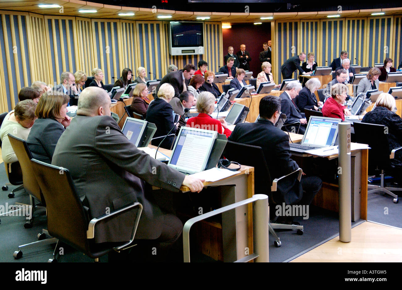 Senedd Welsh Assembly Debating Chamber AMs sit in front of their ...