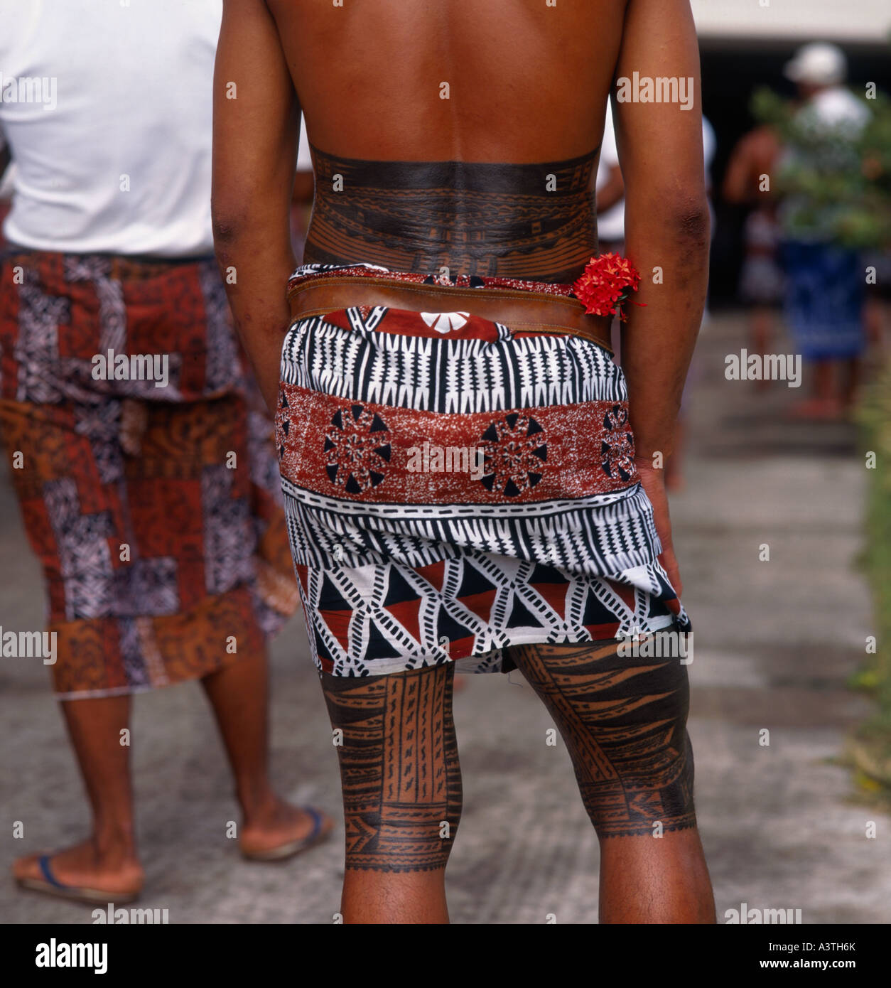 Close up of local young man with bare torso showing traditional tattoos ...