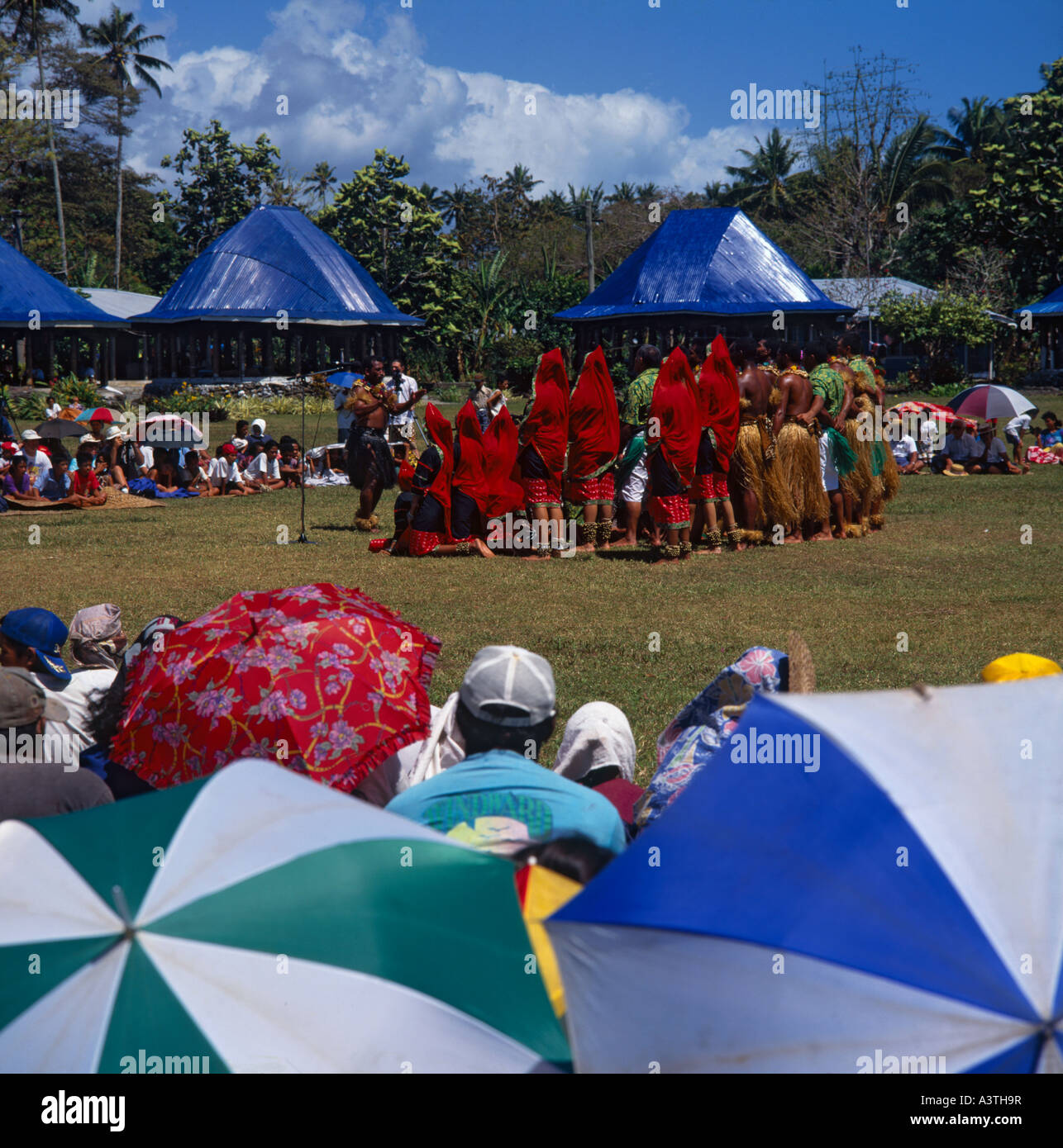 Male Fijian and female Fiji Indian dancers in red dresses perform at ...