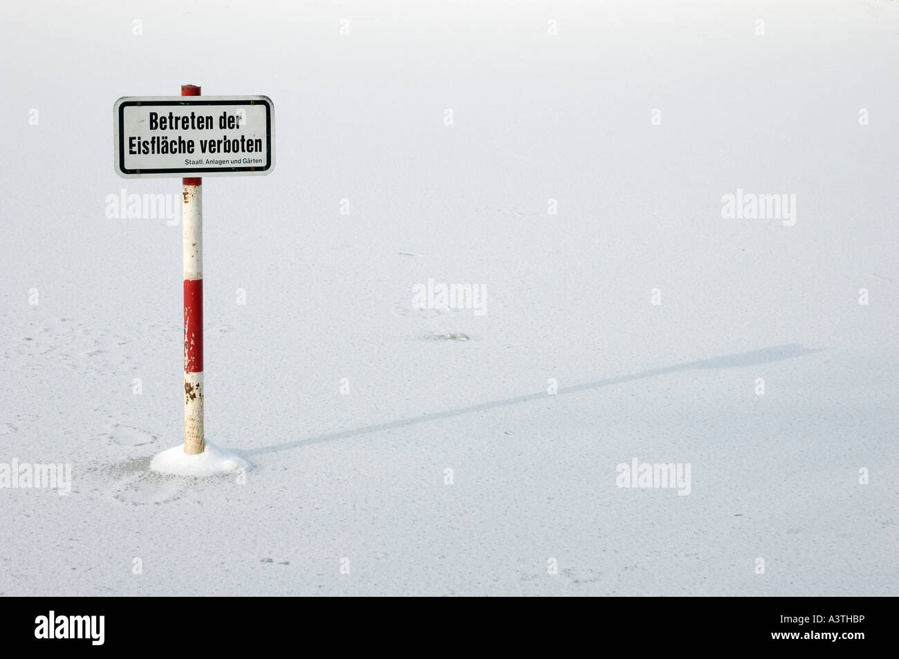 Frozen lake with warning sign Stock Photo - Alamy