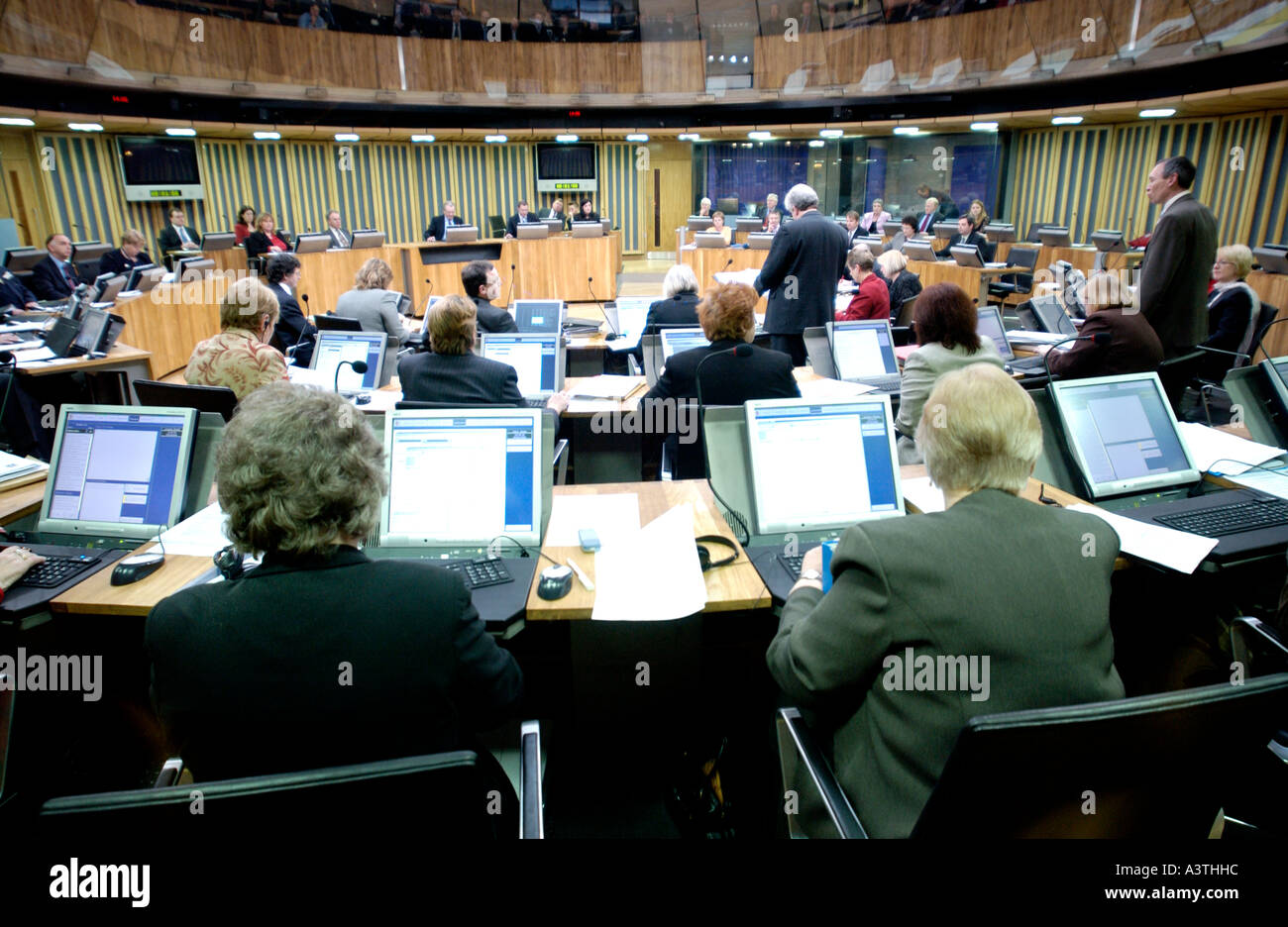 Senedd Welsh Assembly Debating Chamber AMs sit in front of their ...