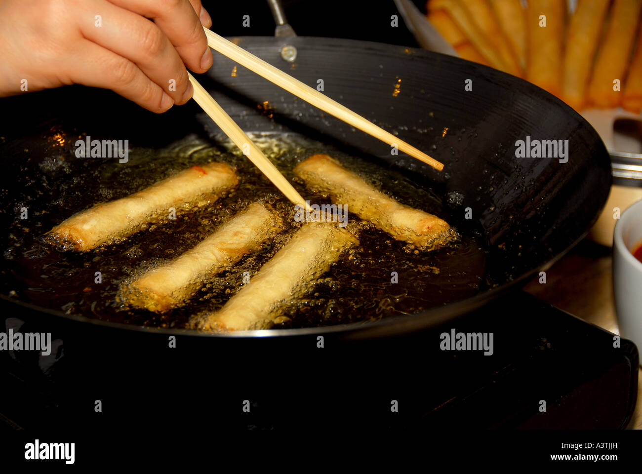 Chinese cuisine spring rolls cooking in wok closeup detail Stock Photo ...