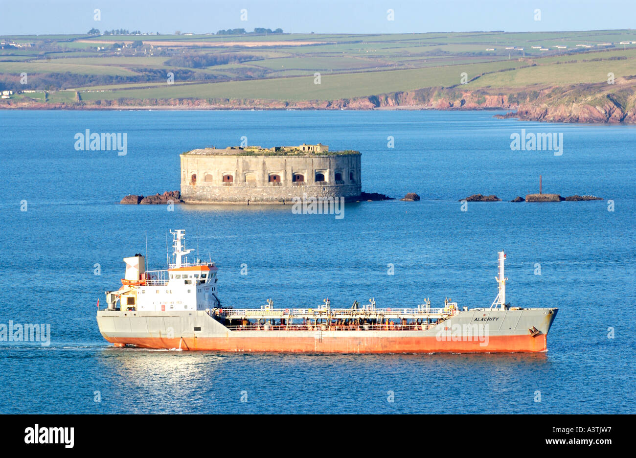 Small coastal oil tanker passing Martello Tower off Angle Milford Haven ...