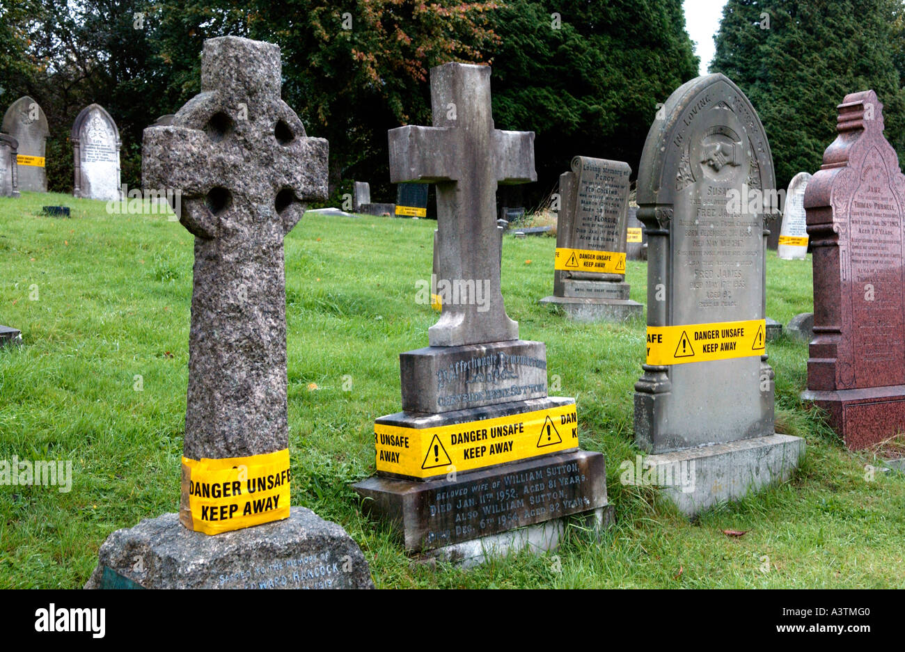 Unsafe headstones with yellow warning notices at a cemetery in Risca ...
