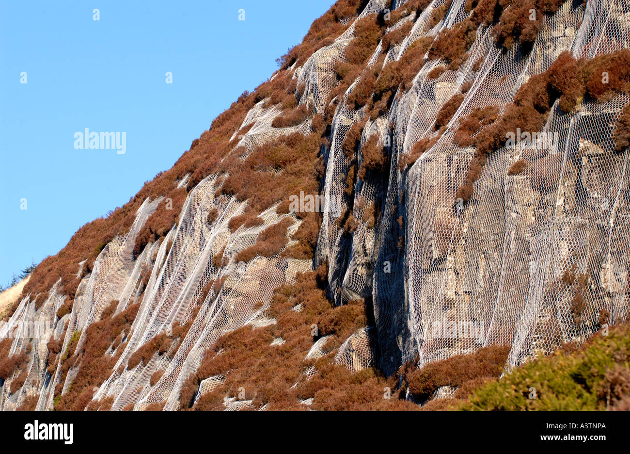 Protective metal mesh covering loose rock on the A4061 above Treherbert ...