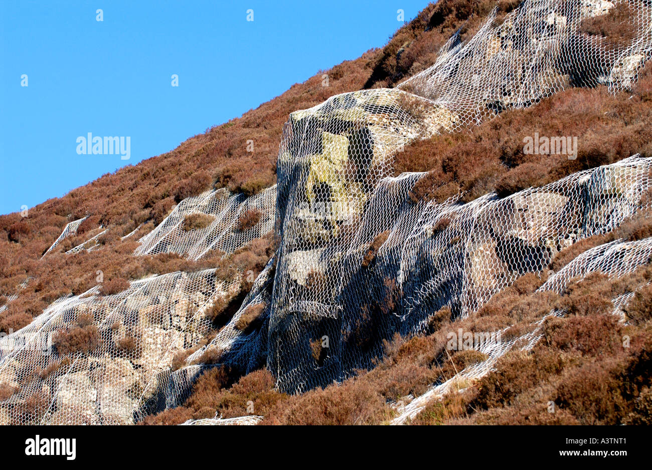 Protective metal mesh covering loose rock on the A4061 above Treherbert ...
