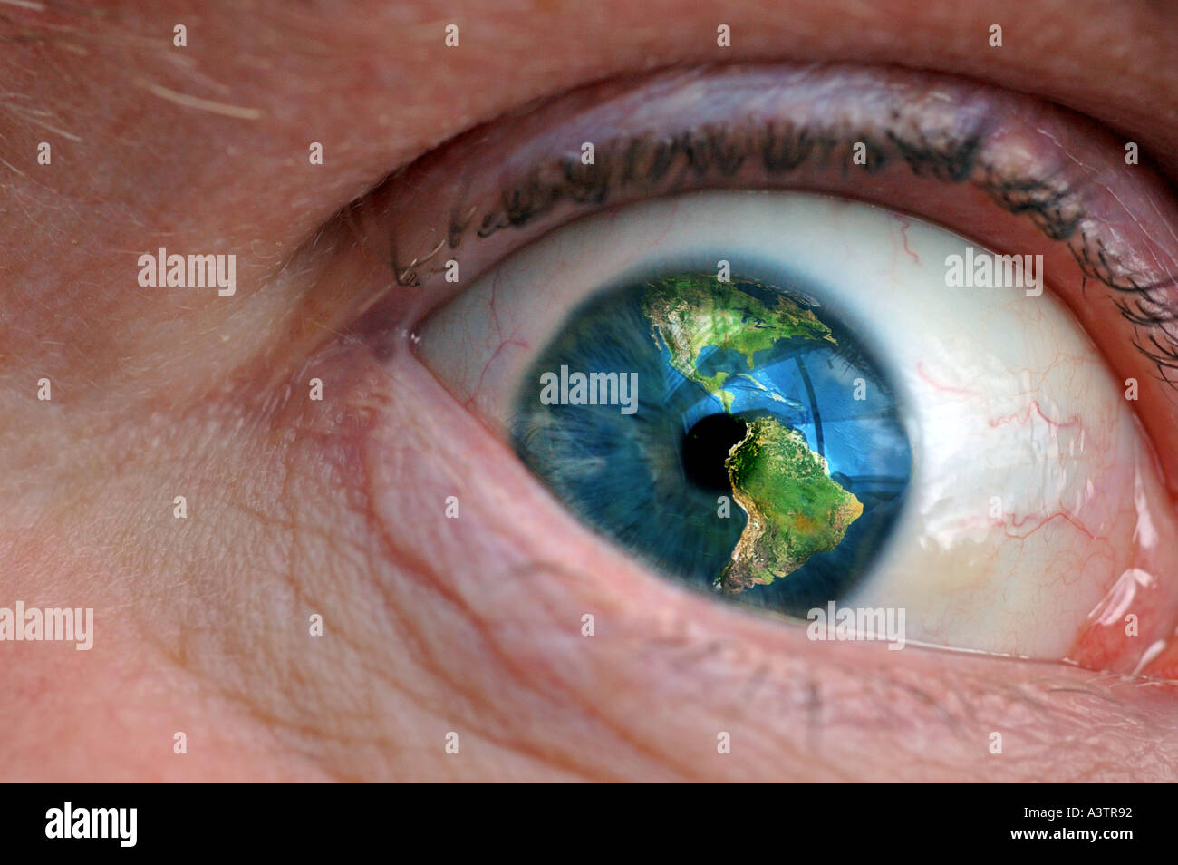 Eye with earth reflected in it and North and South America ...