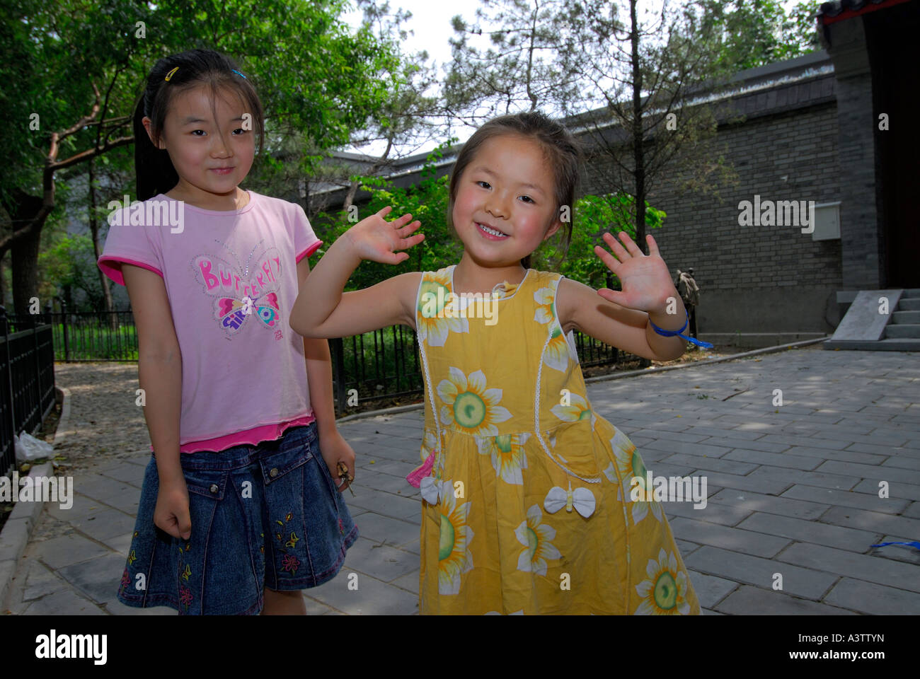 Two Chinese girls playing in the lanes of Beijing Hutongs China Stock ...