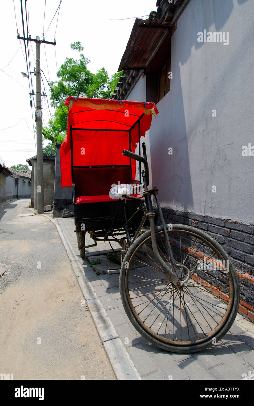 Chinese rickshaw waiting in narrow lanes of Beijing Hutong China Stock ...
