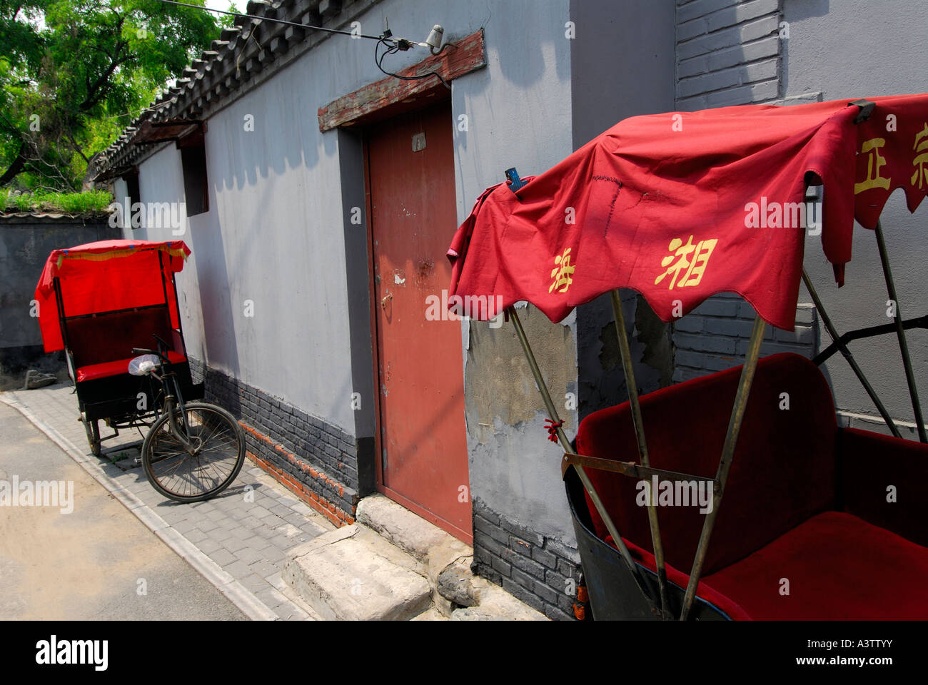 Chinese pedicabs waiting in narrow lanes of Beijing Hutong China Stock ...