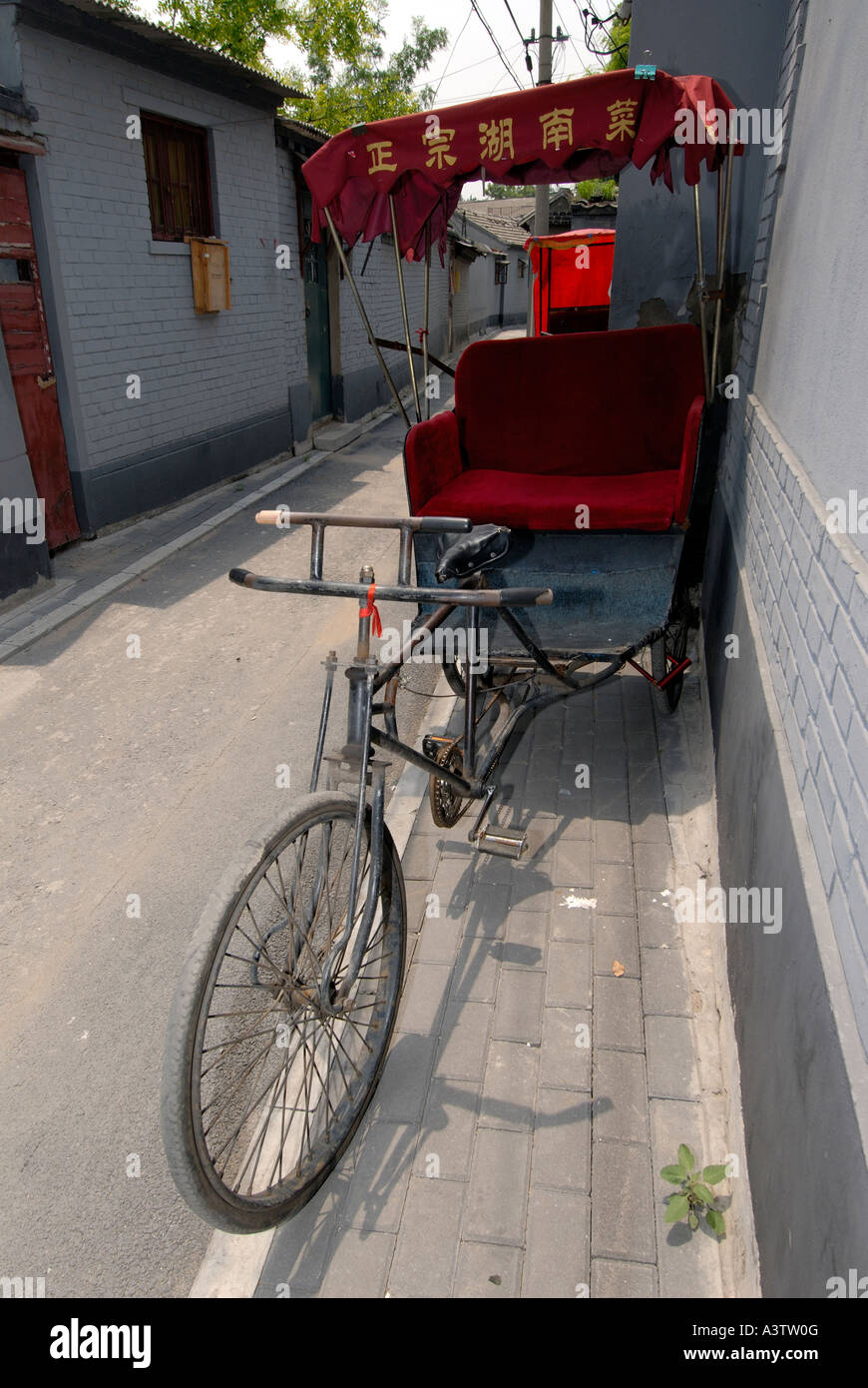 Chinese rickshaw waiting in narrow lanes of Beijing Hutong China Stock ...